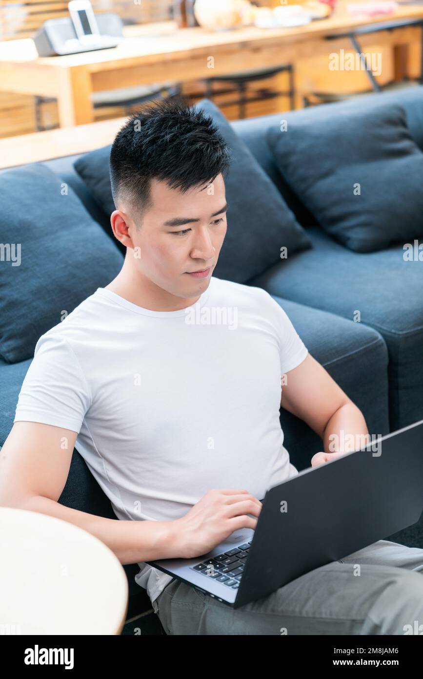 Young men who use a computer Stock Photo - Alamy