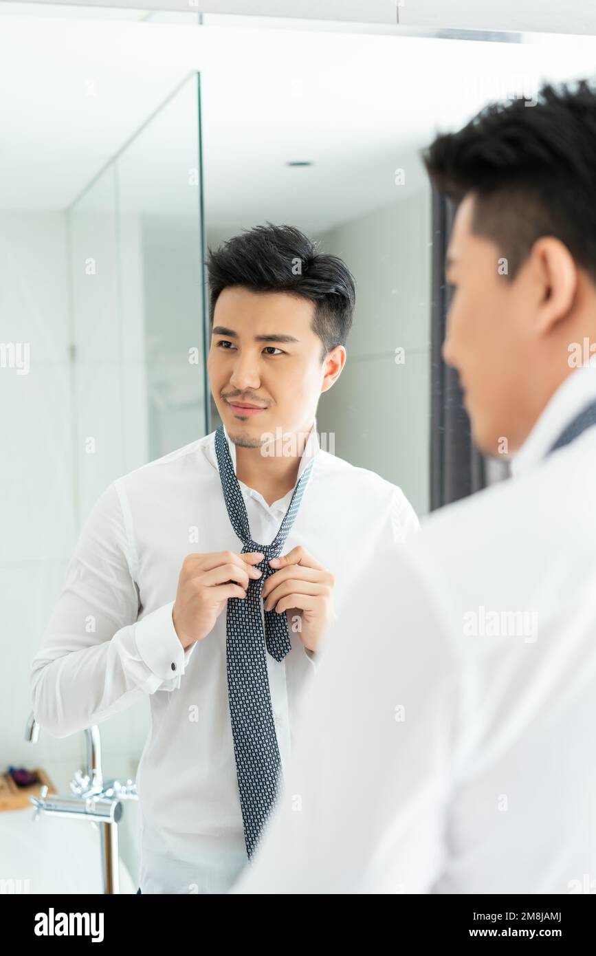 Young man standing in front of mirror hi-res stock photography and ...