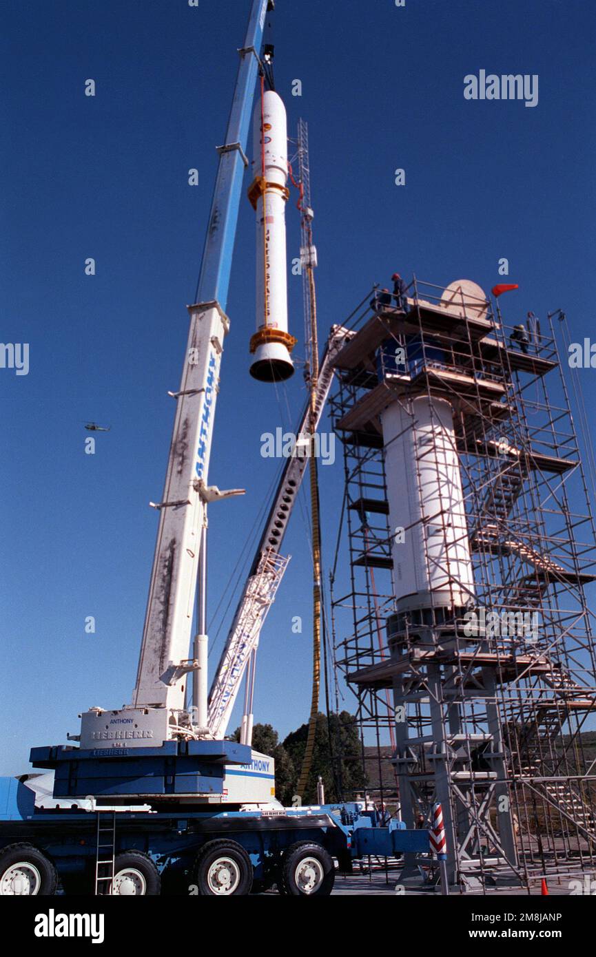 The second and third stages of the Taurus Rocket are lifted up onto the ...