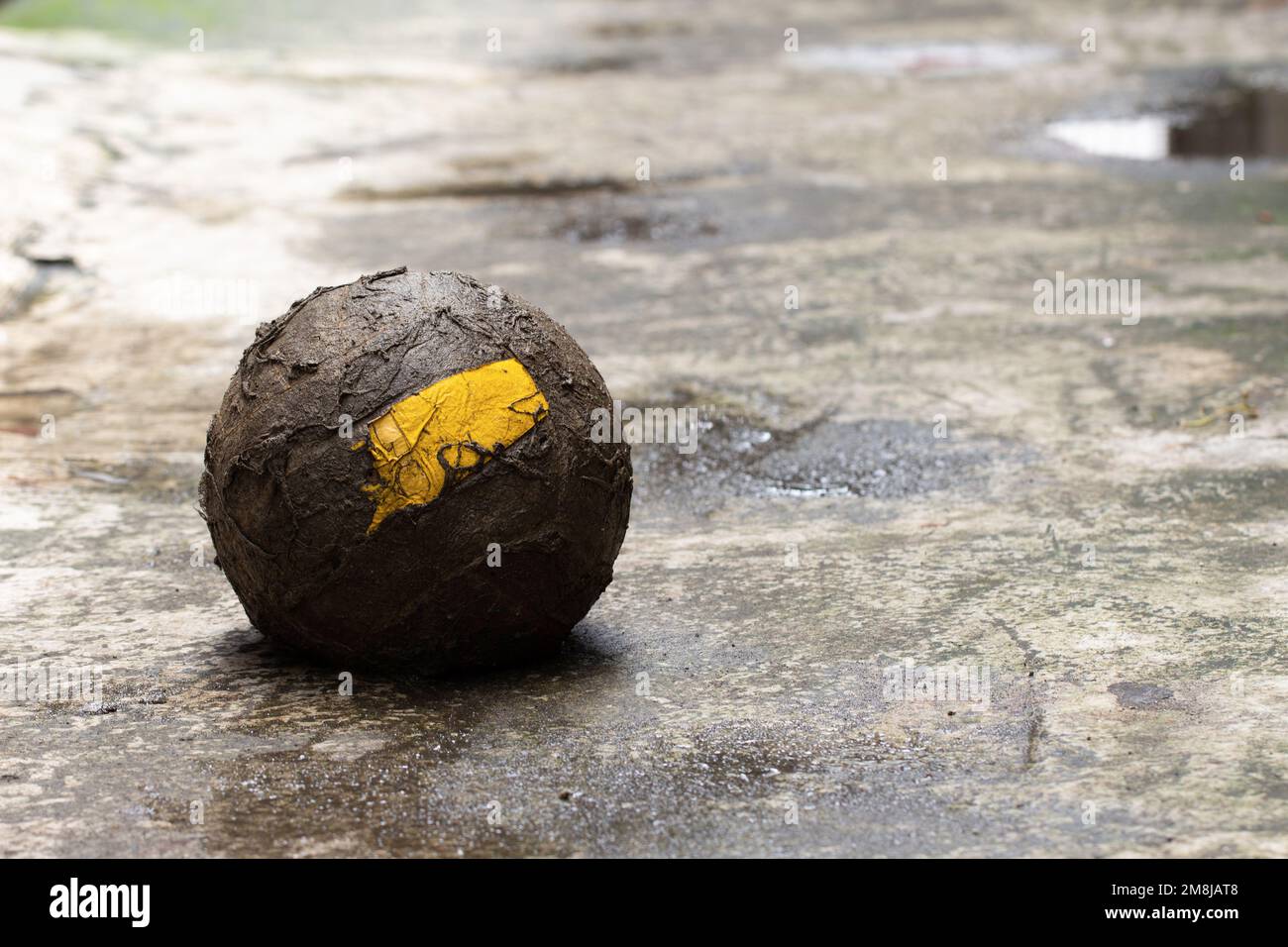 close up of a broken ball on a rain-soaked street on floor Stock Photo ...