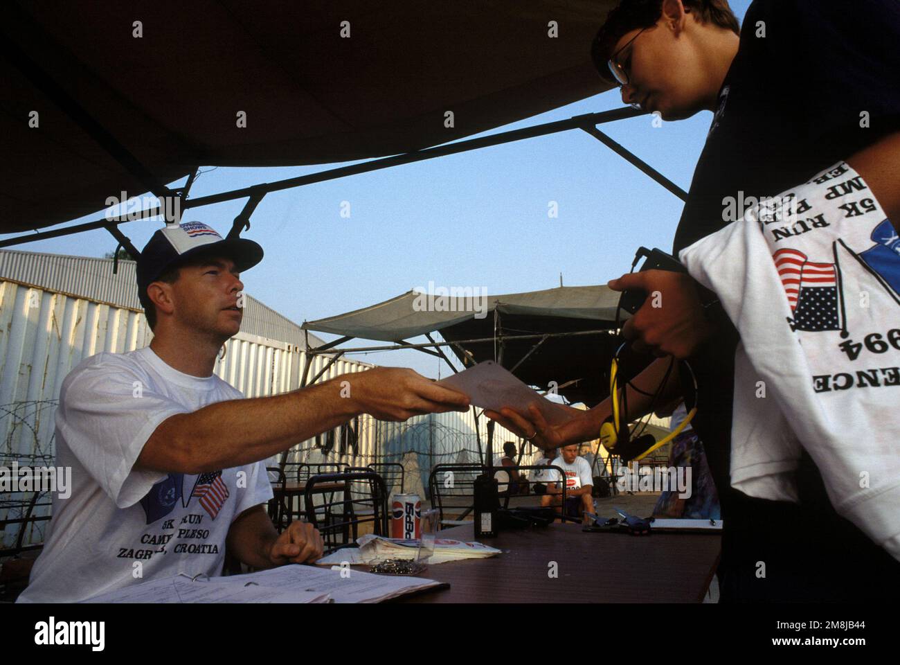 HM3 Stacy Johnson, US Navy, receives her number from MAJ. Tom Crossman ...