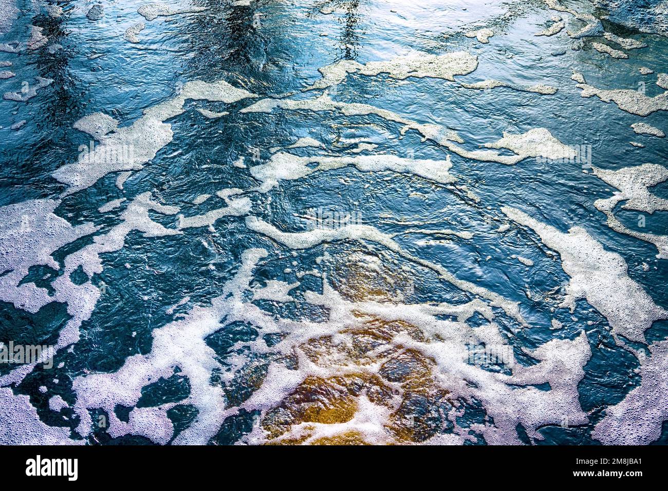 Brown swamp water full of organic substances flows down the pipe and ...