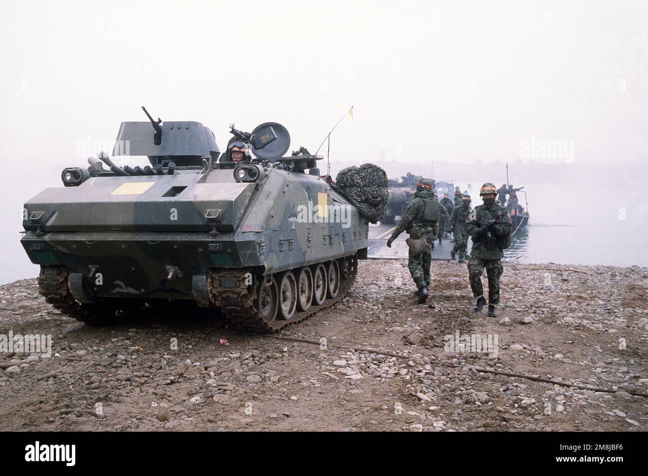 A Republic of Korea Armored Personnel Carrier (APC) moves up the shore ...