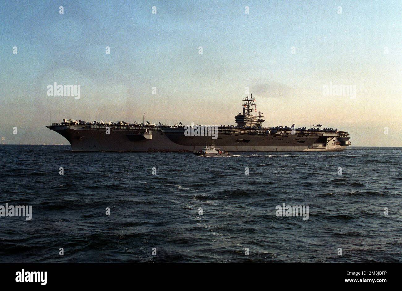 A port side view of the nuclear-powered aircraft carrier USS CARL ...