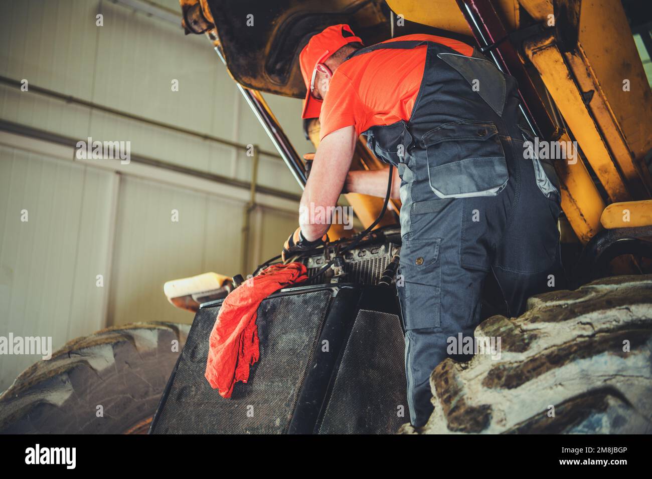 Caucasian Heavy Machinery Mechanic Performing Tractor Maintenance Stock ...