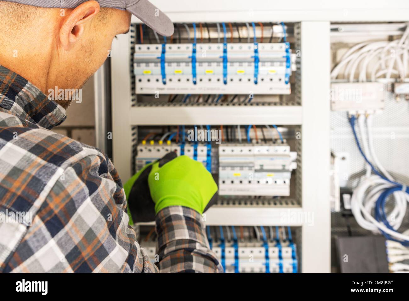 Caucasian Electrician Contractor Installing Residential Electric Fuse ...