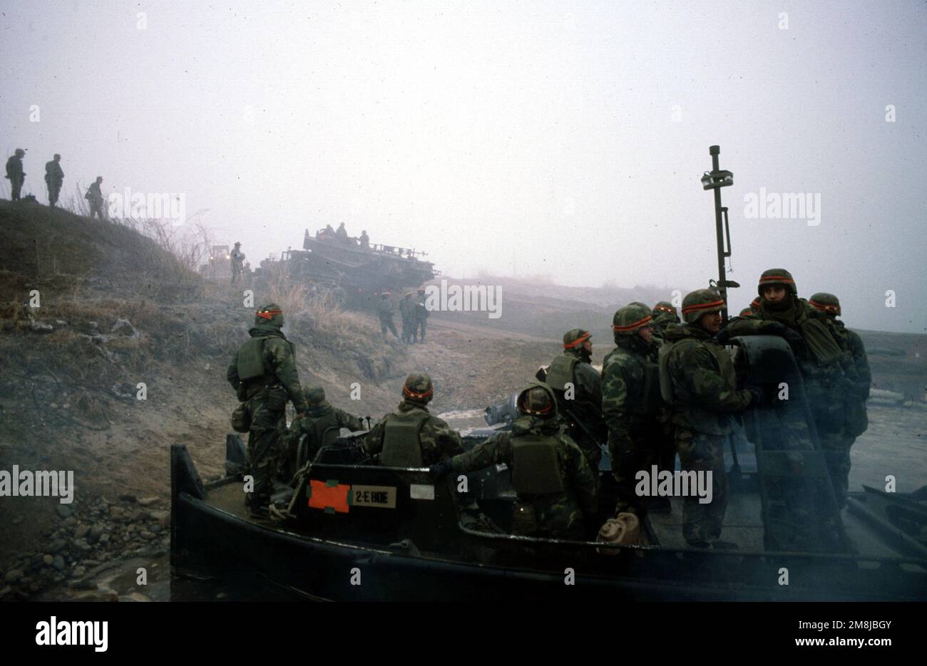 Soldiers from the 50th Engineers Assault Float Bridge Company wait on ...