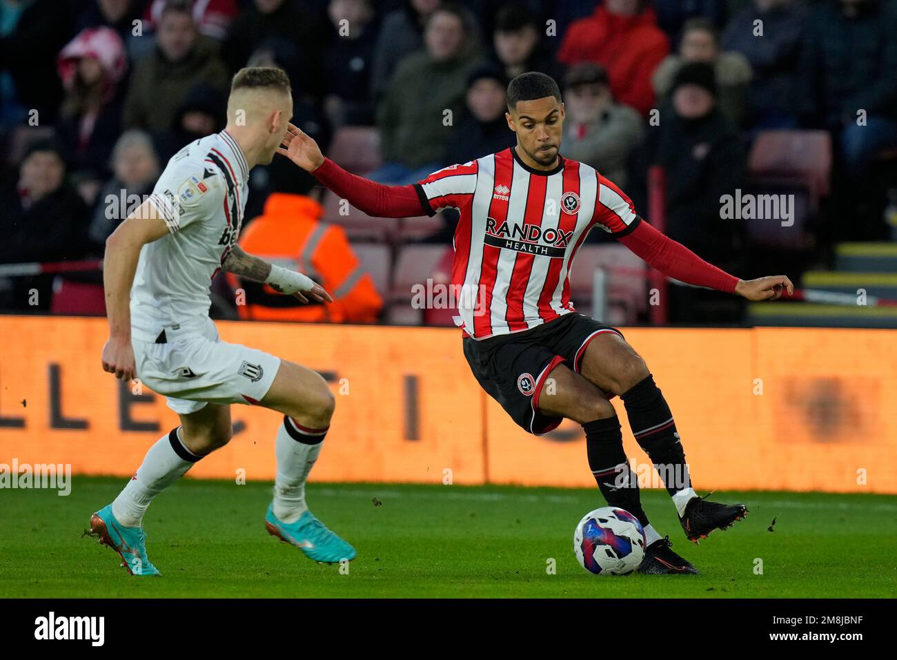 Max Lowe #13 of Sheffield United runs at Ben Wilmot #16 of Stoke City ...