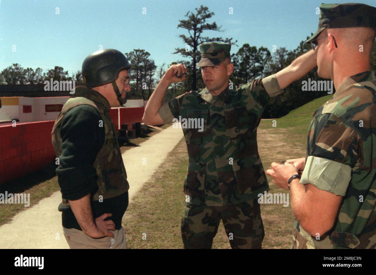 Undersecretary of Navy Richard Danzig is instructed how to properly ...