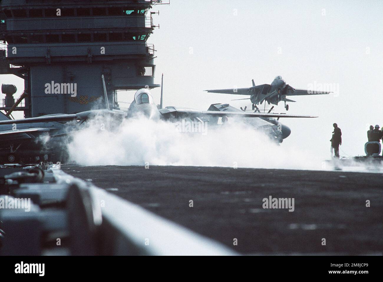 An F-14A Tomcat aircraft prepares to launch from the number one ...