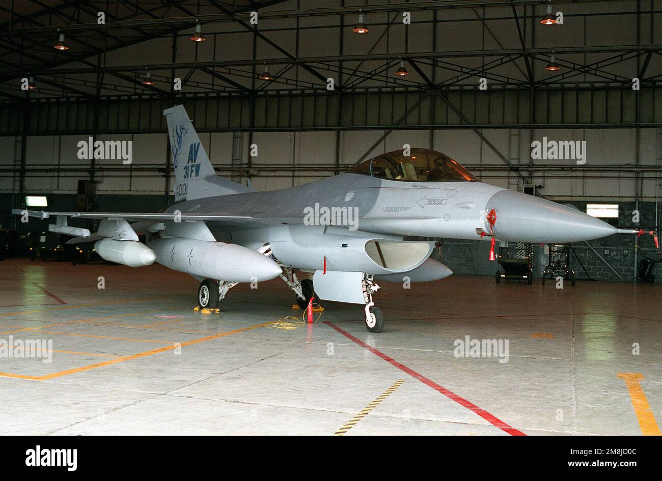 A newly painted F-16 Fighting Falcon stands on display in a hangar ...