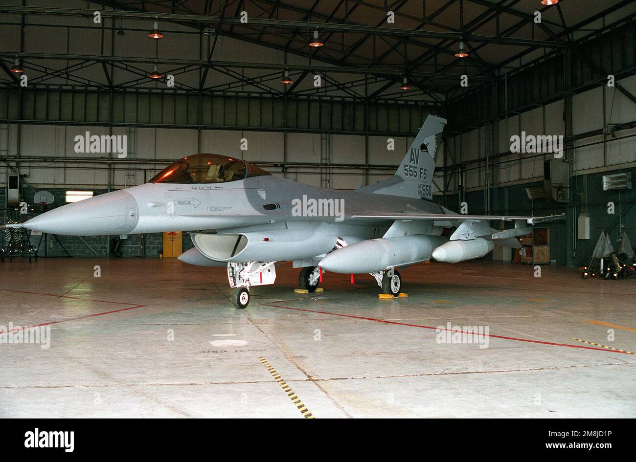 A newly painted F-16 Fighting Falcon stands on display in a hangar ...