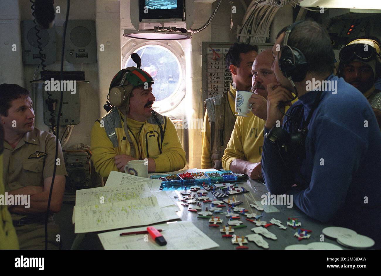 The handler, flight deck officers and watchstanders monitor aircraft ...