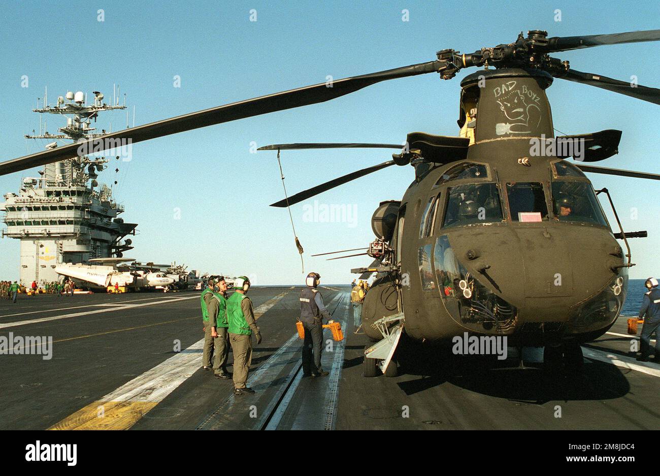 Flight deck crews and Army personnel do preflight checks on a U.S. Army ...