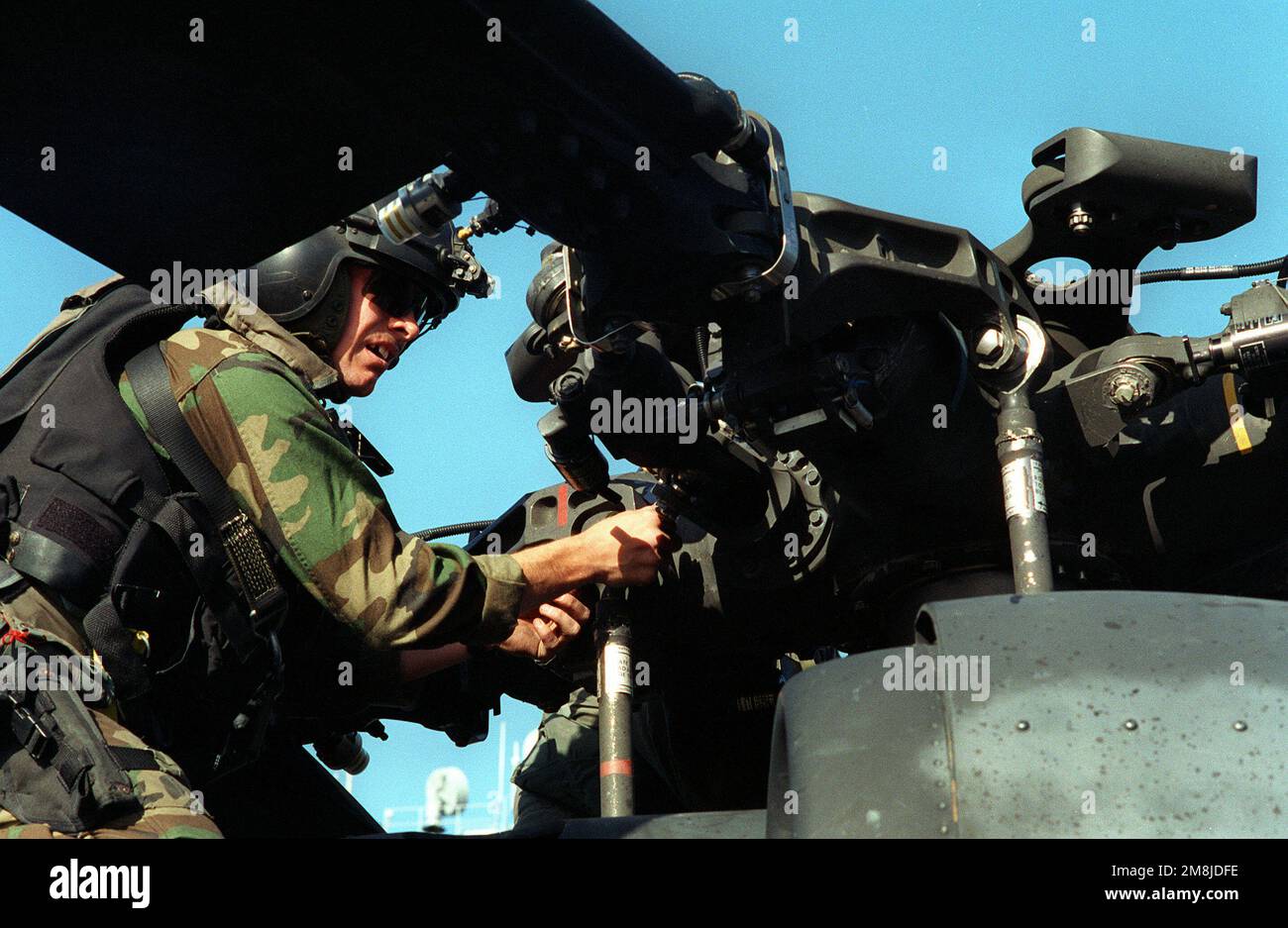 A crewmember of a U.S. Army MH-60 Black Hawk (Blackhawk) command and ...