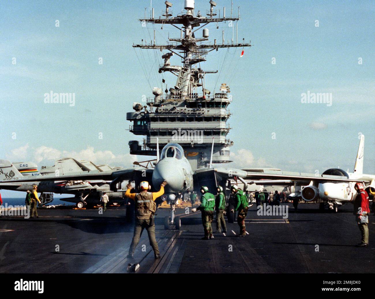 A flight deck crewman aboard the nuclear-powered aircraft carrier USS ...