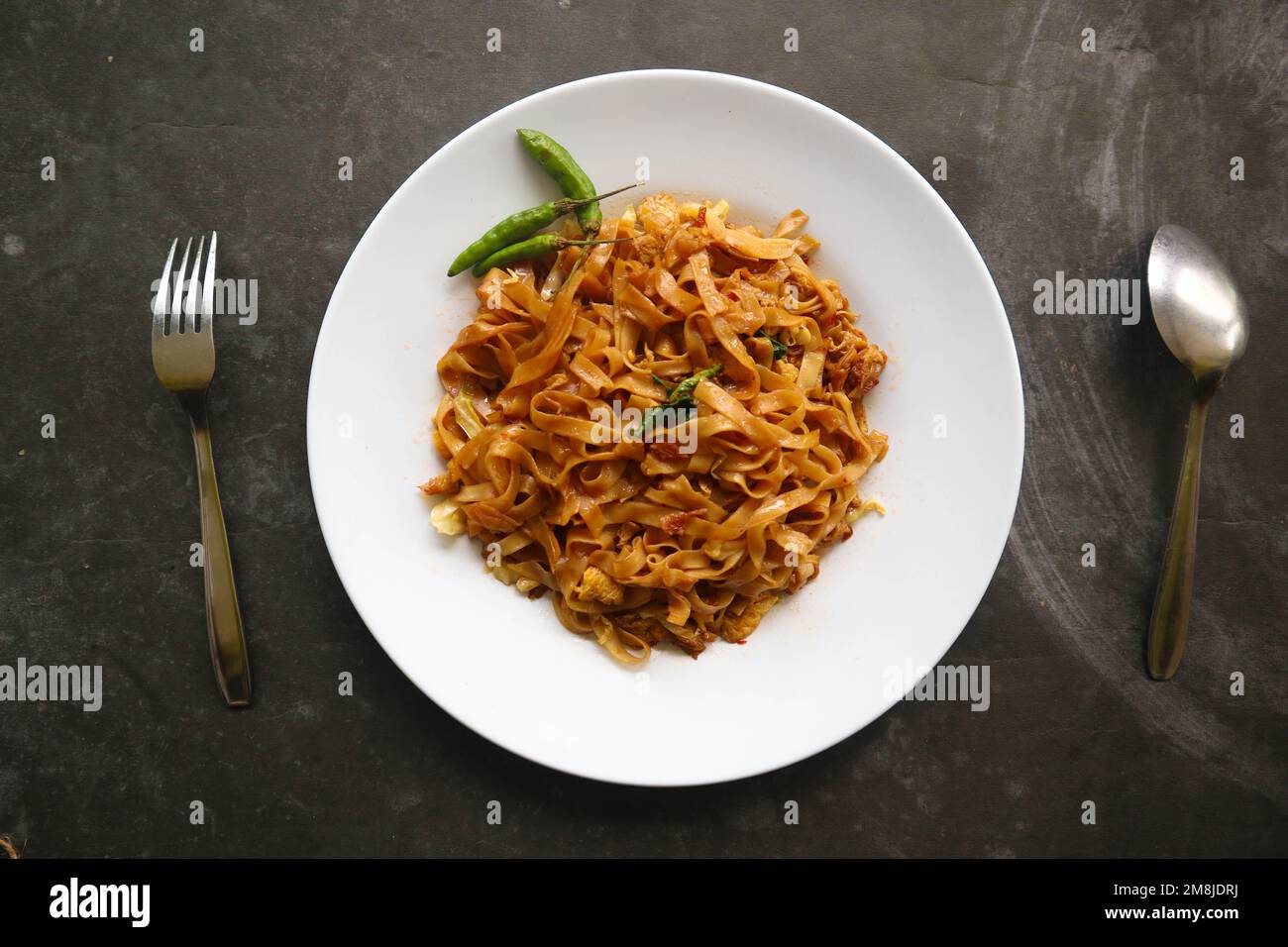 Kwetiau goreng is Chinese Indonesian stir fried flat rice noodle dish ...