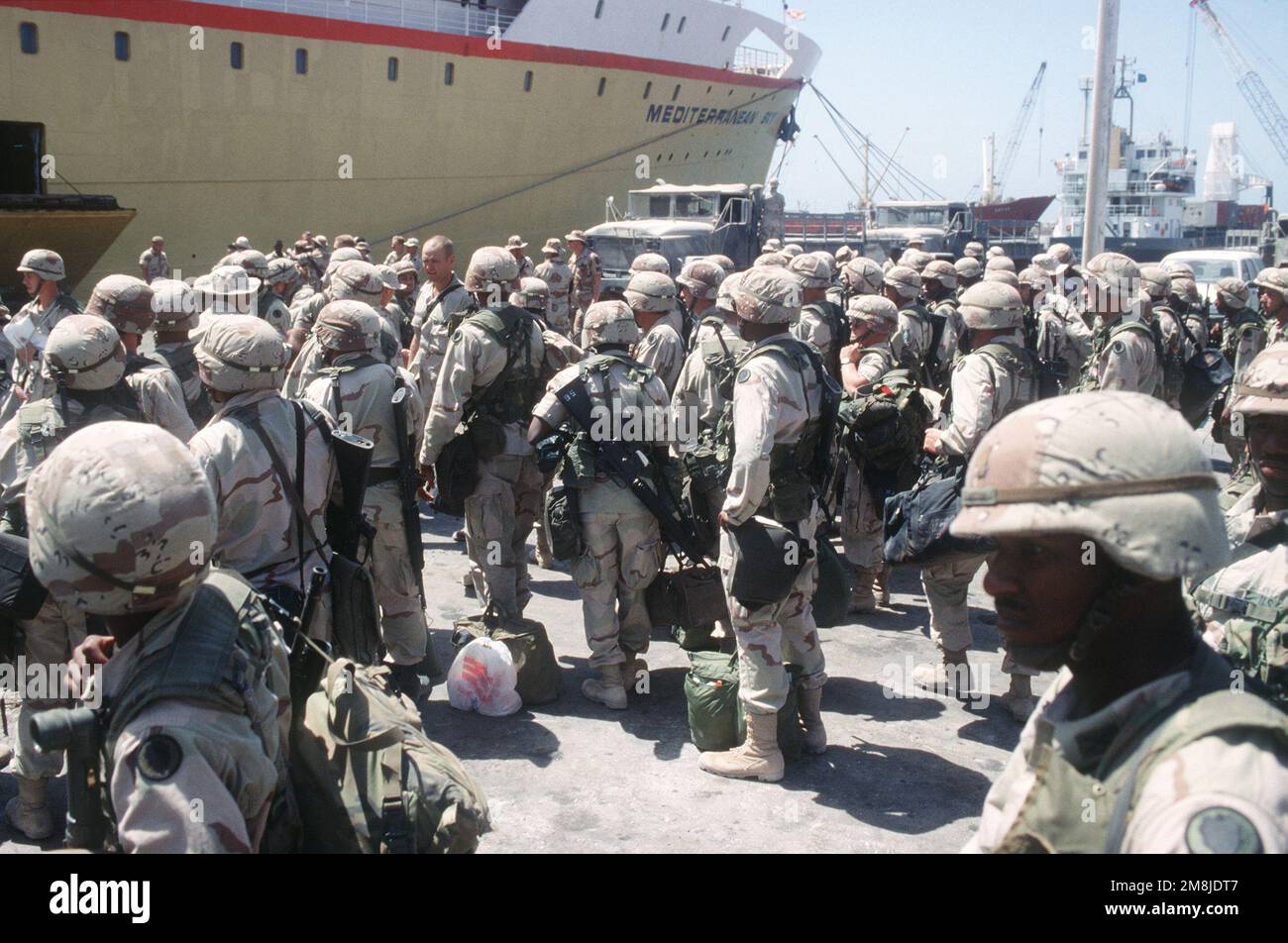 U.S. Army soldiers wait at Mogadishu seaport to board the Military ...