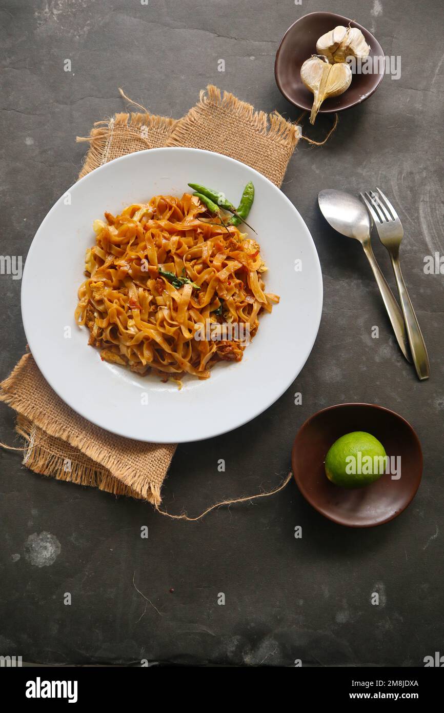 Kwetiau goreng is Chinese Indonesian stir fried flat rice noodle dish ...