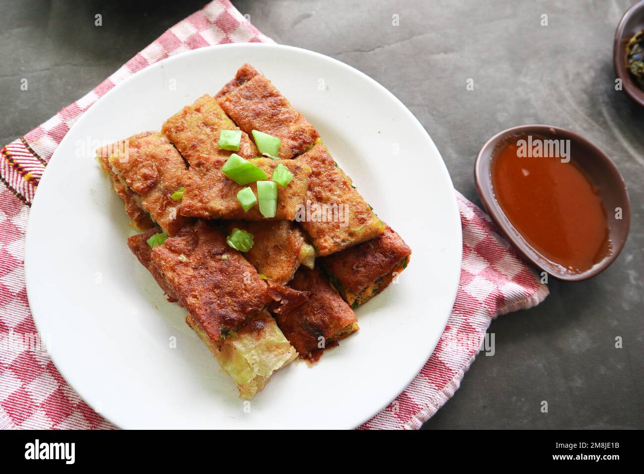 Martabak Telor or Murtabak Telur or mutabbaq. Savory pan-fried pastry ...