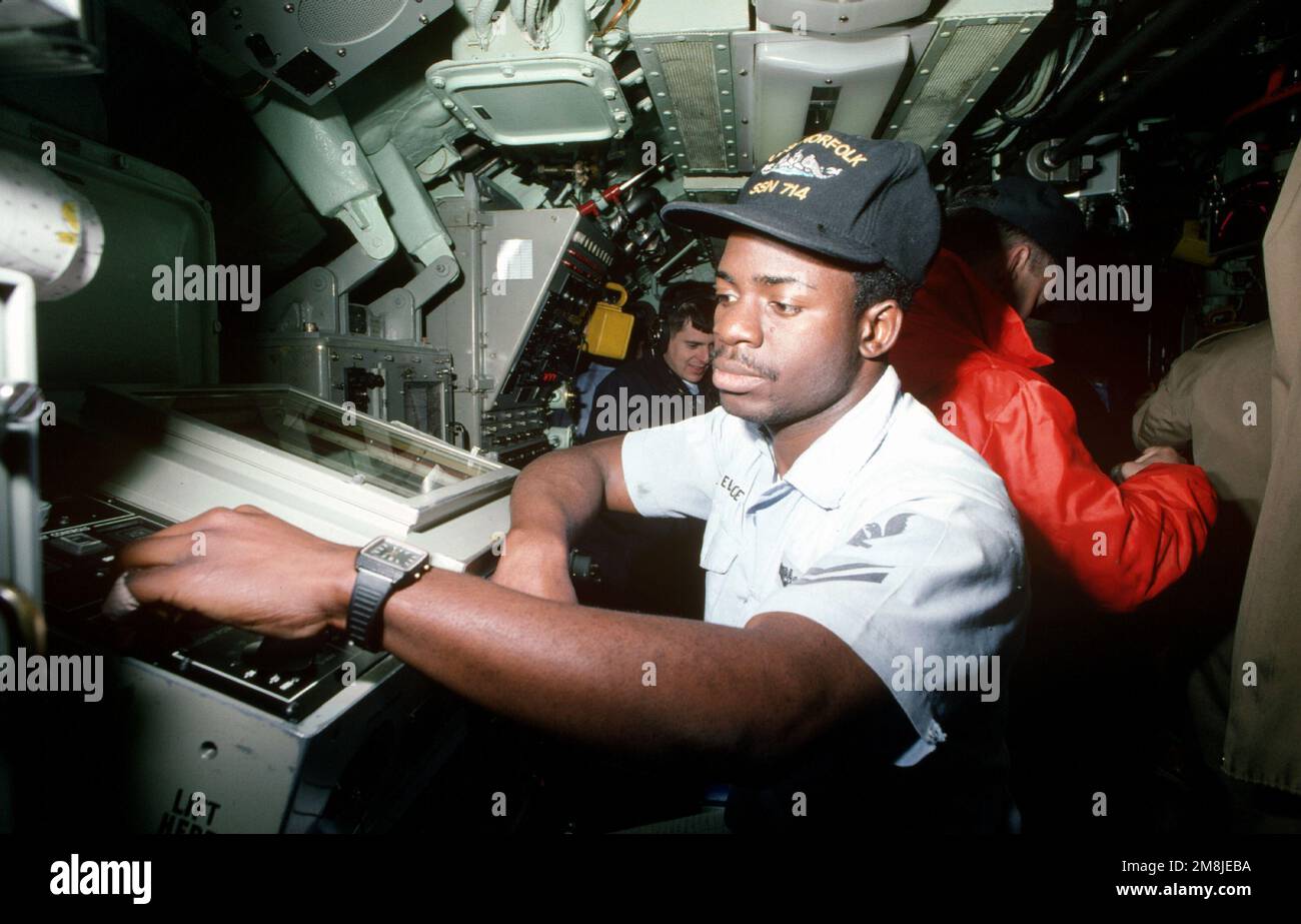 Sonar Technician Second Class (ST2) Kenneth Elmore runs a fathometer ...