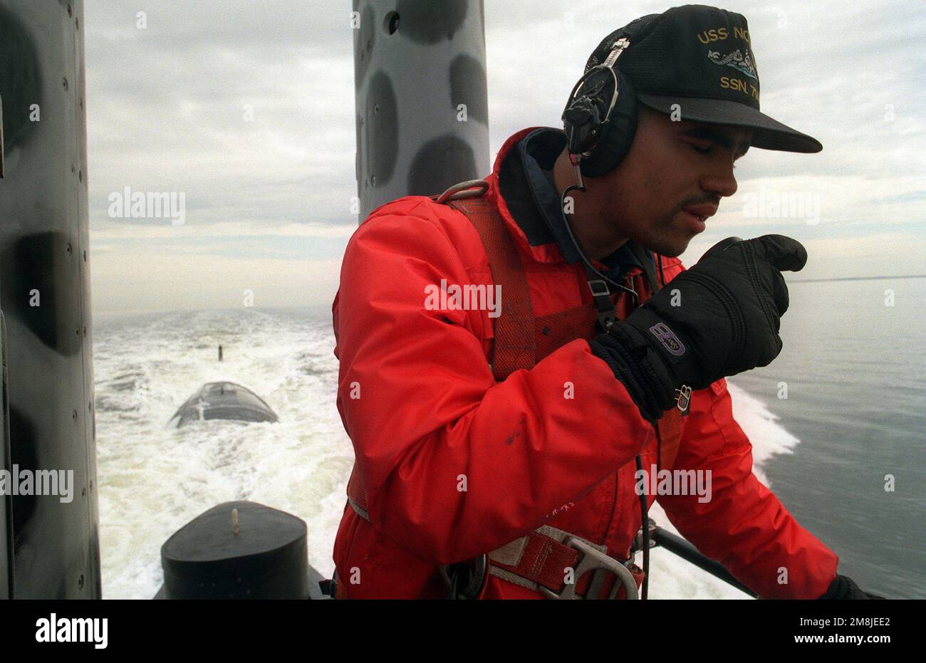 Storekeeper Second Class (SK2) David Stewart stands the phone watch on ...