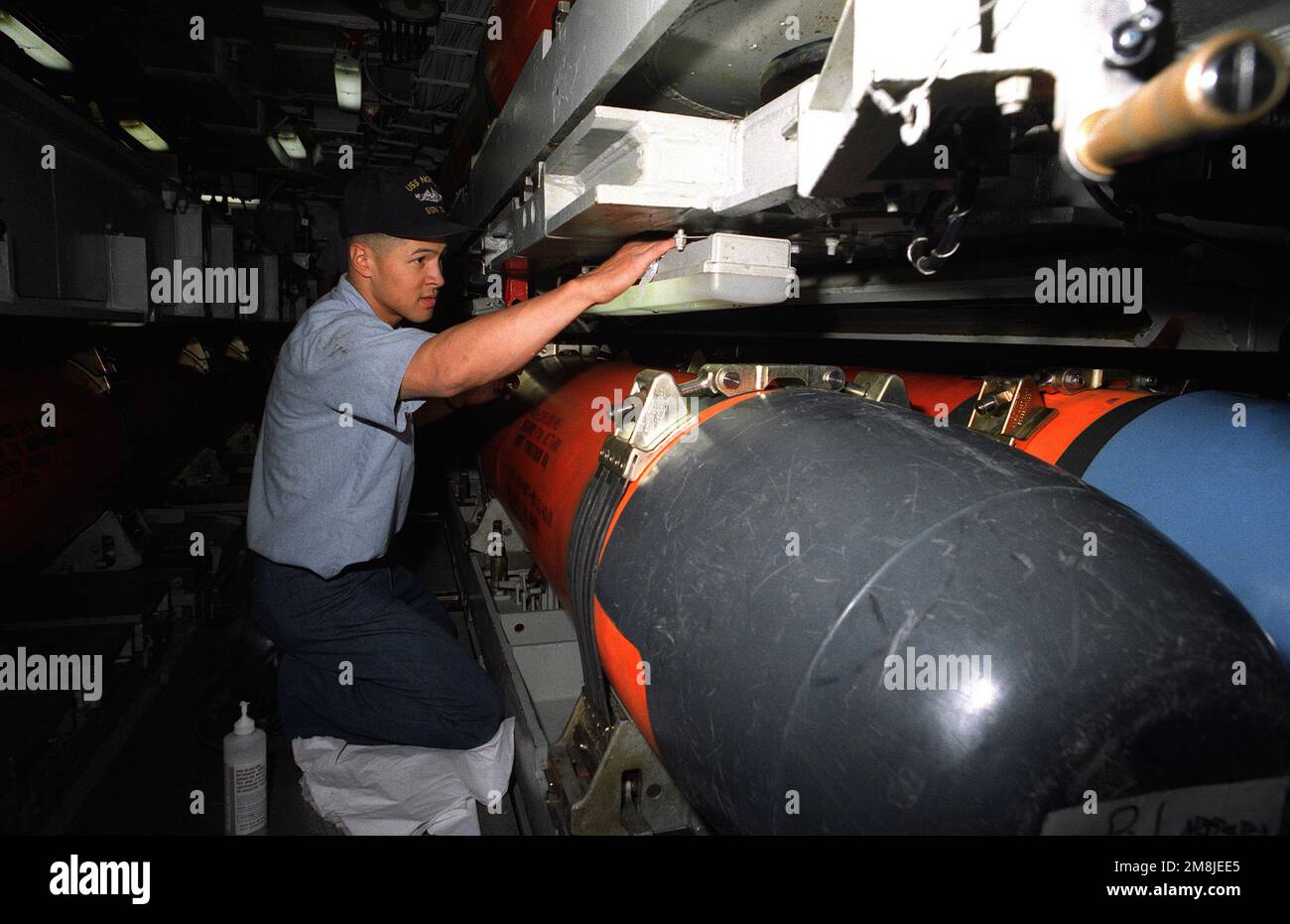 Torpedoman SEAMAN (TMSN) Tracy Jennings helps clean the torpedo room ...