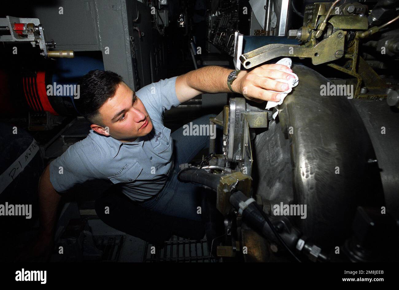 Torpedoman Third Class (TM3) Kent Laquez inspects an exercise torpedo ...