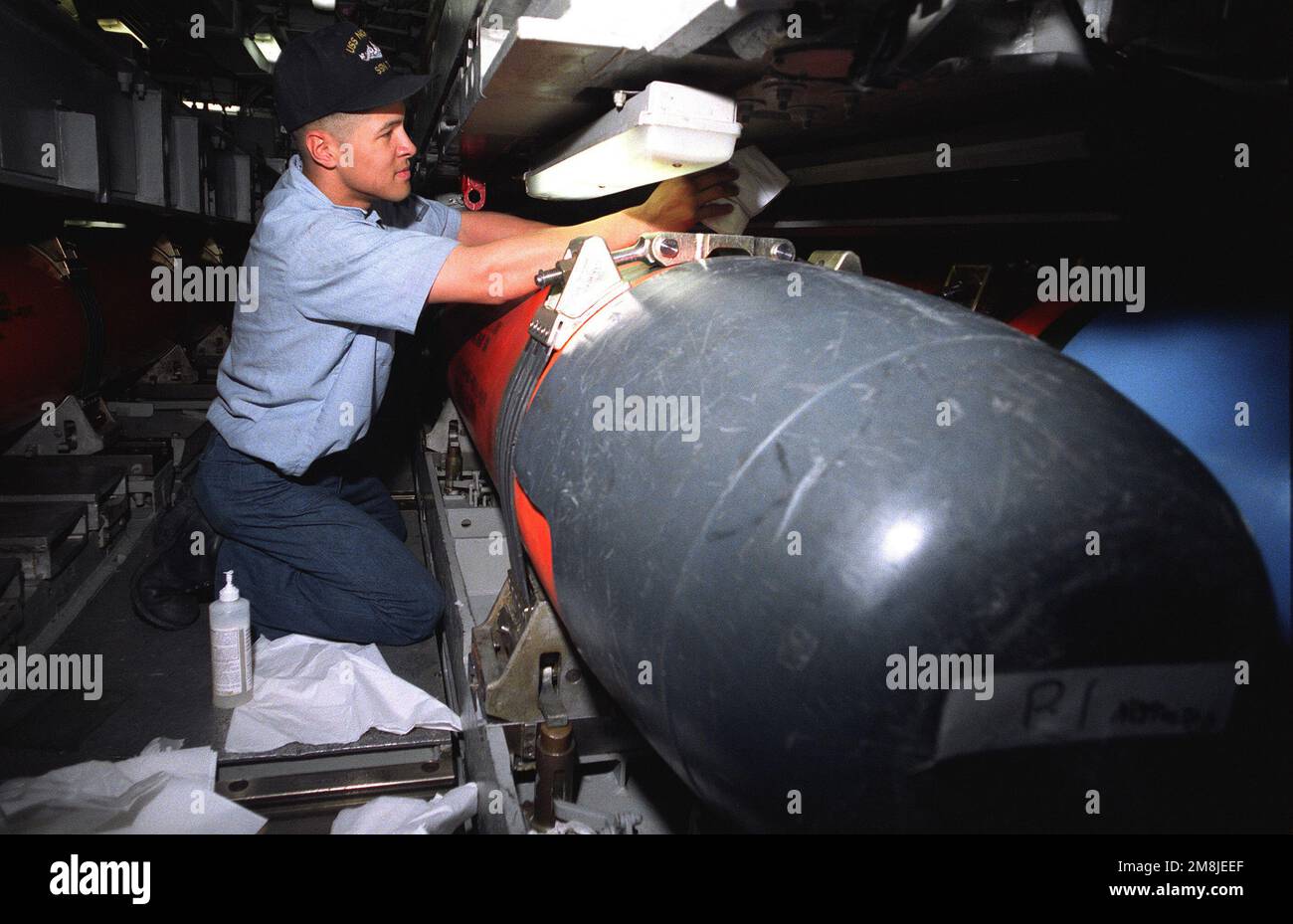 Torpedoman SEAMAN (TMSN) Tracy Jennings assist in cleaning the torpedo ...