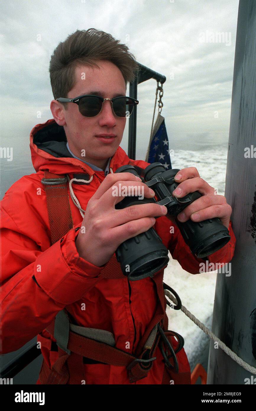 SEAMAN (SN) Chad Plambeck stands the lookout watch on the sail of the ...