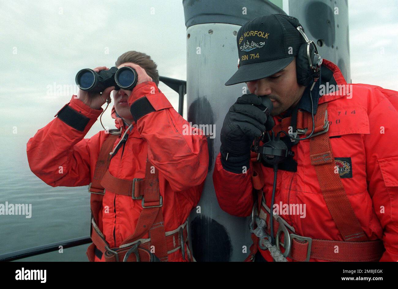 SEAMAN (SN) Chad Plambeck stands lookout as Storekeeper Second Class ...