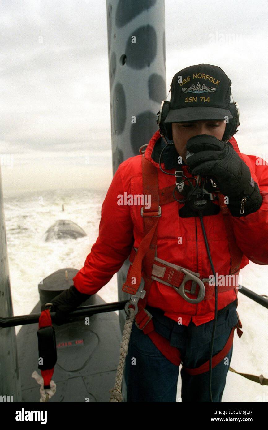 Storekeeper Second Class (SK2) David Stewart relays messages from the ...