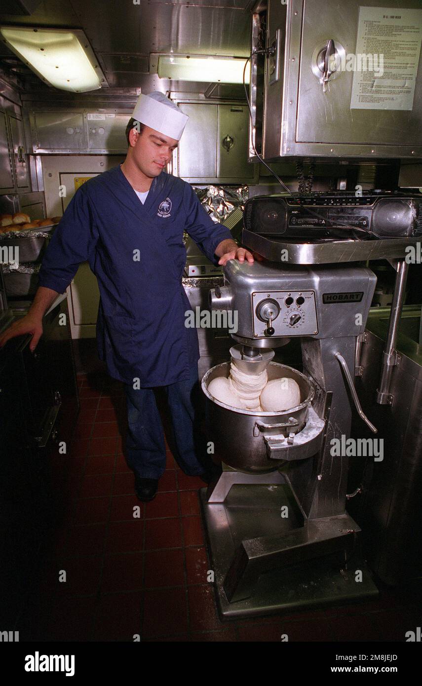 Mess SPECIALIST Third Class (MS3) Tim Martin makes bread dough in the ...