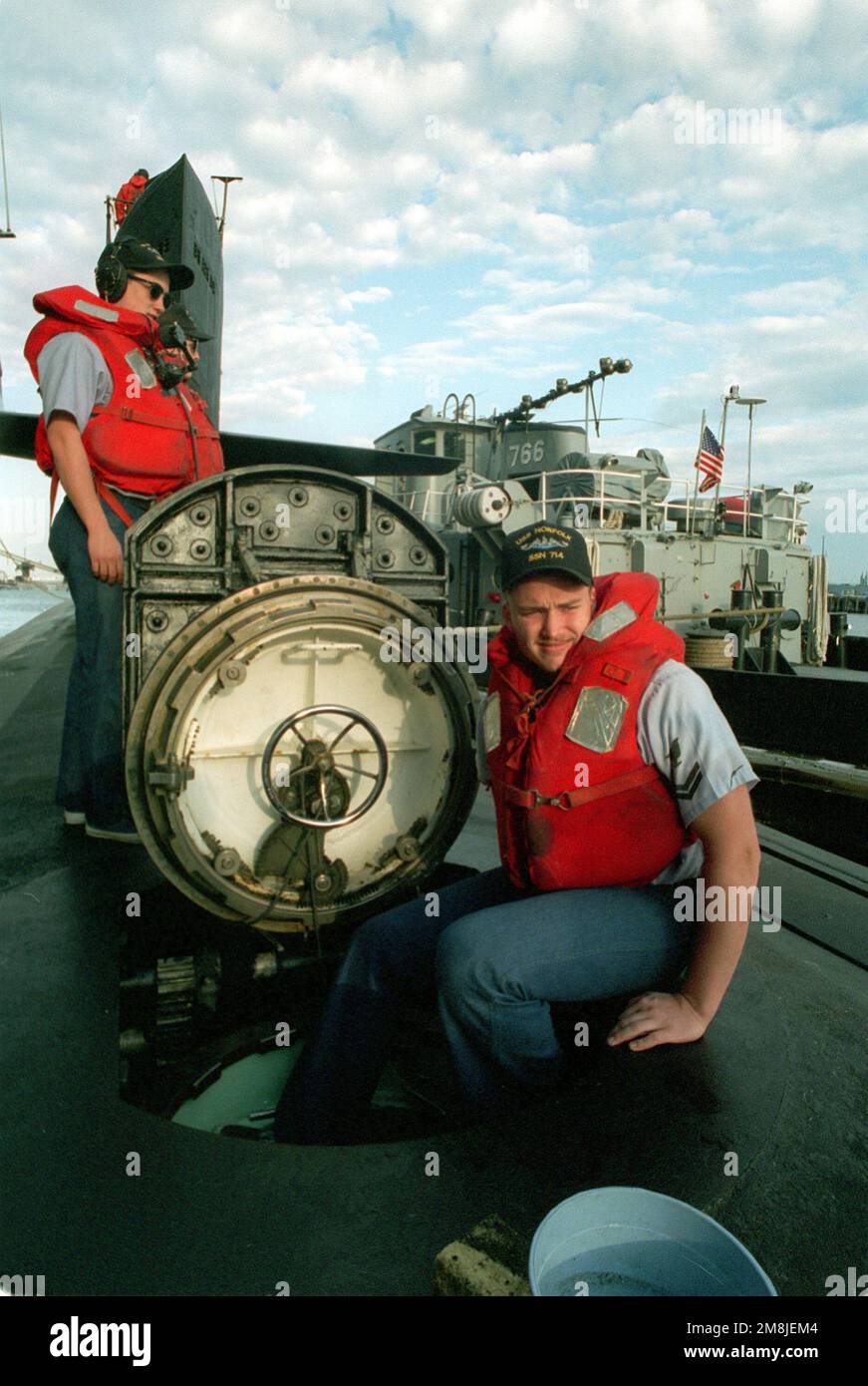 Hospital Corpsman (HM1) Wayne Aldrich takes the temperature of Sonar ...