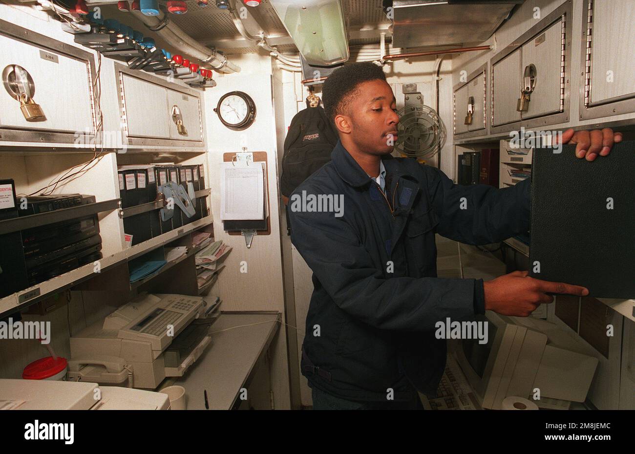 Yeoman Third Class (YN3) Clifton Williams working in the yeoman's ...