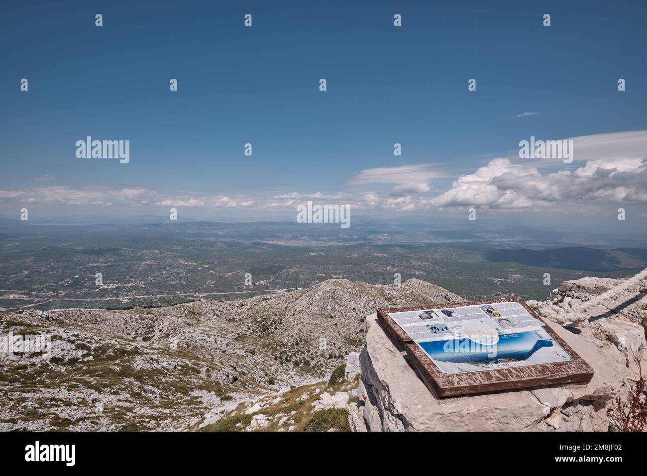 The view from a lookout point on top of a mountain with a map of the ...