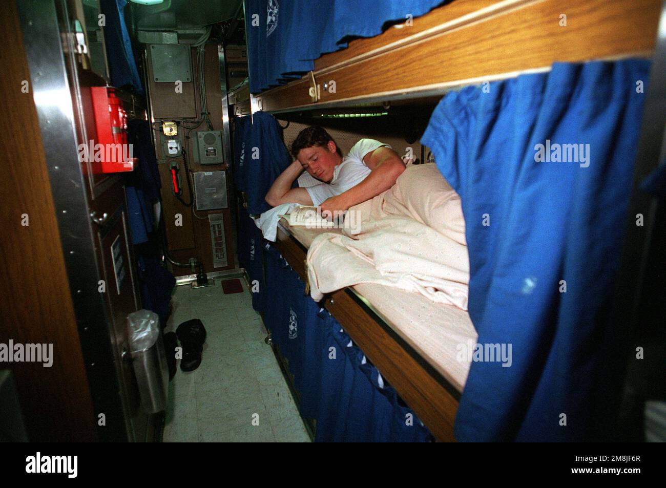 Tim Sullivan enjoys his off duty time by reading a book in his rack ...