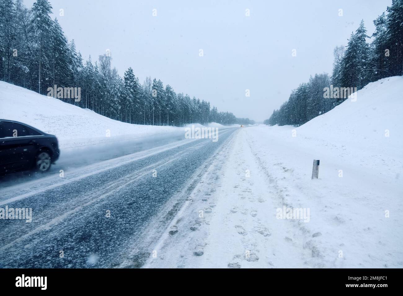The highway is covered with snow, obstructed traffic, continuous ...