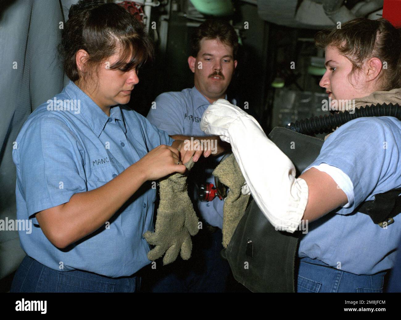 Hull Maintenance Technician Second Class (HT2) Joseph E. Bailey grinds ...