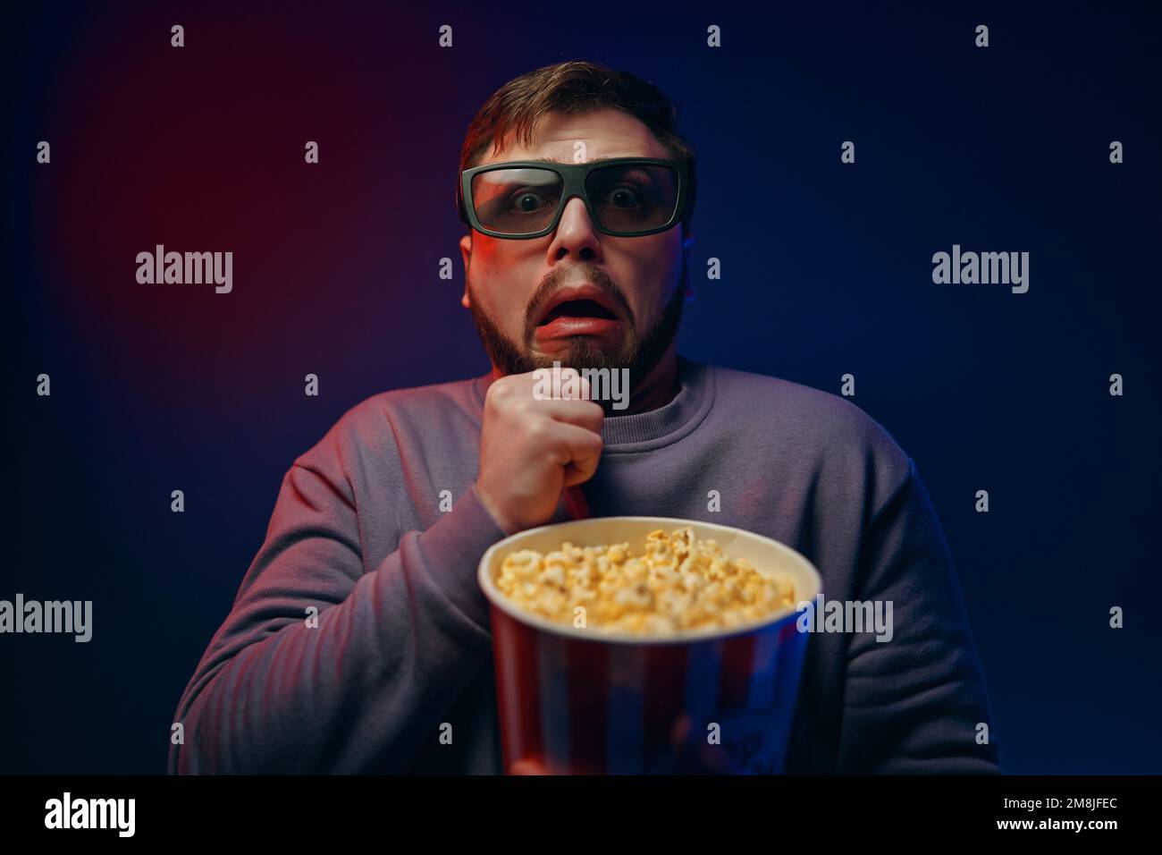 A man watches horror movies. The emotion of fear Stock Photo - Alamy