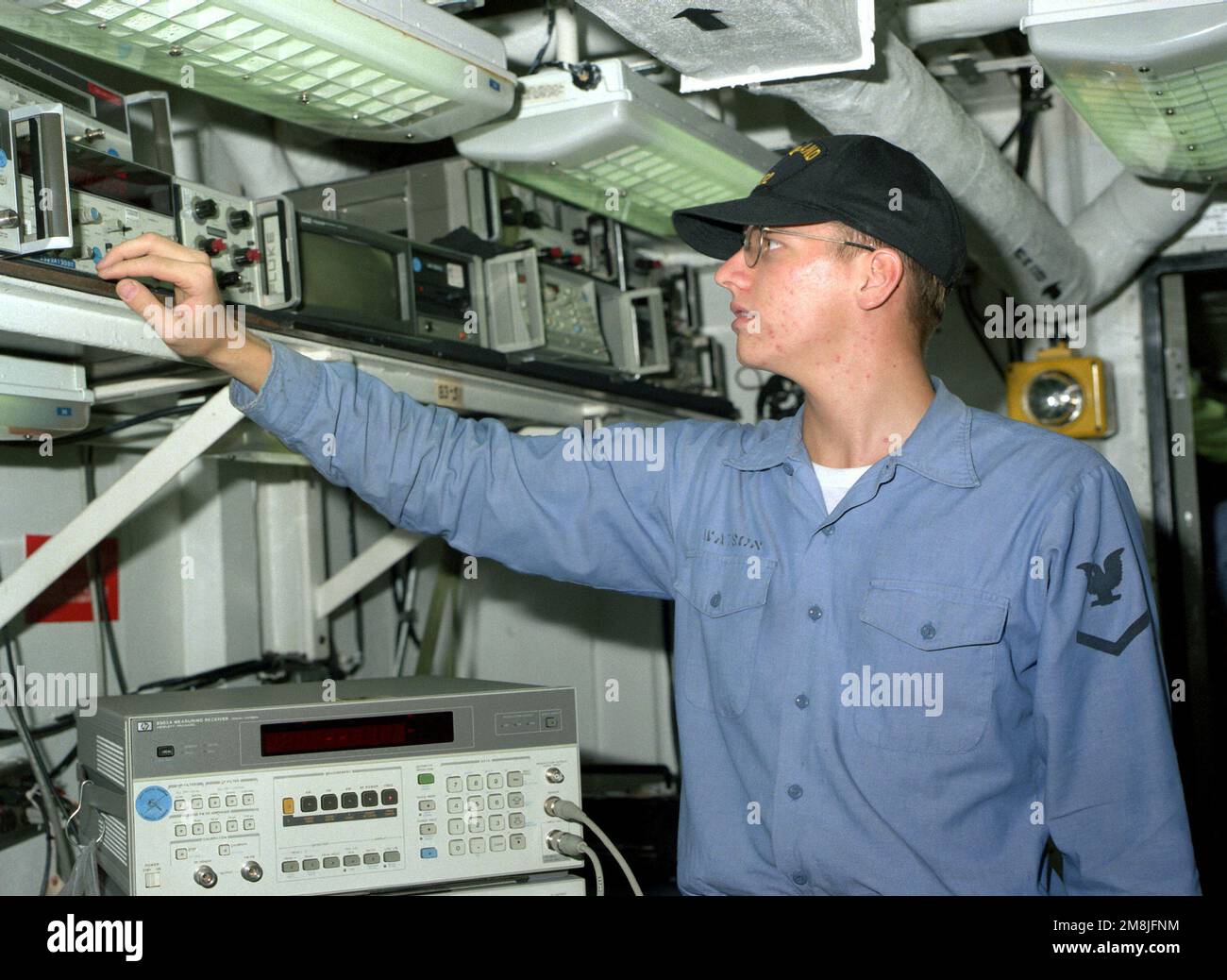Electronic Technician Third Class (ET3) Timothy L. Watson hooks up and ...