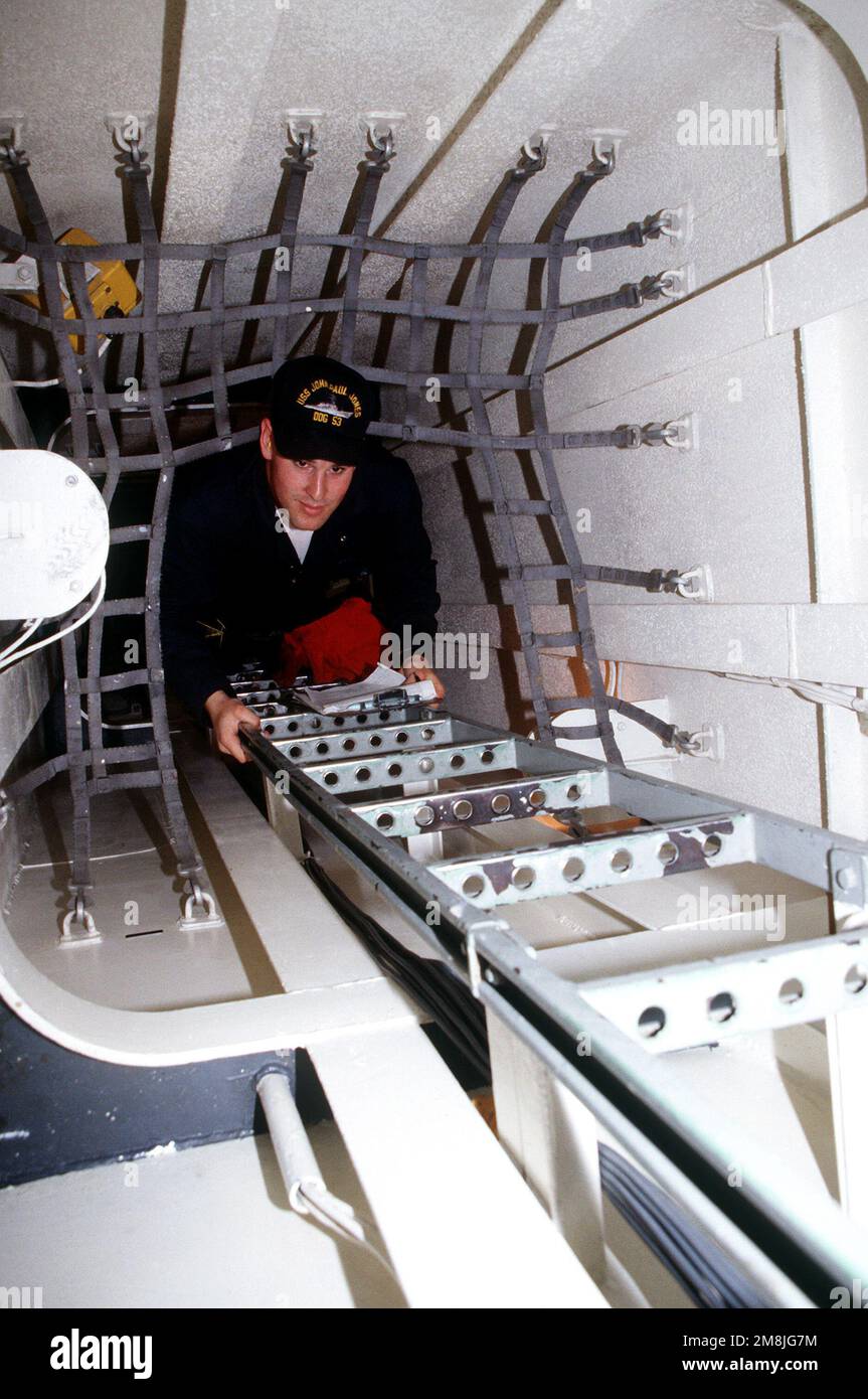 Hull Technician Third Class (HT3) Scott Shroll makes his way down to ...
