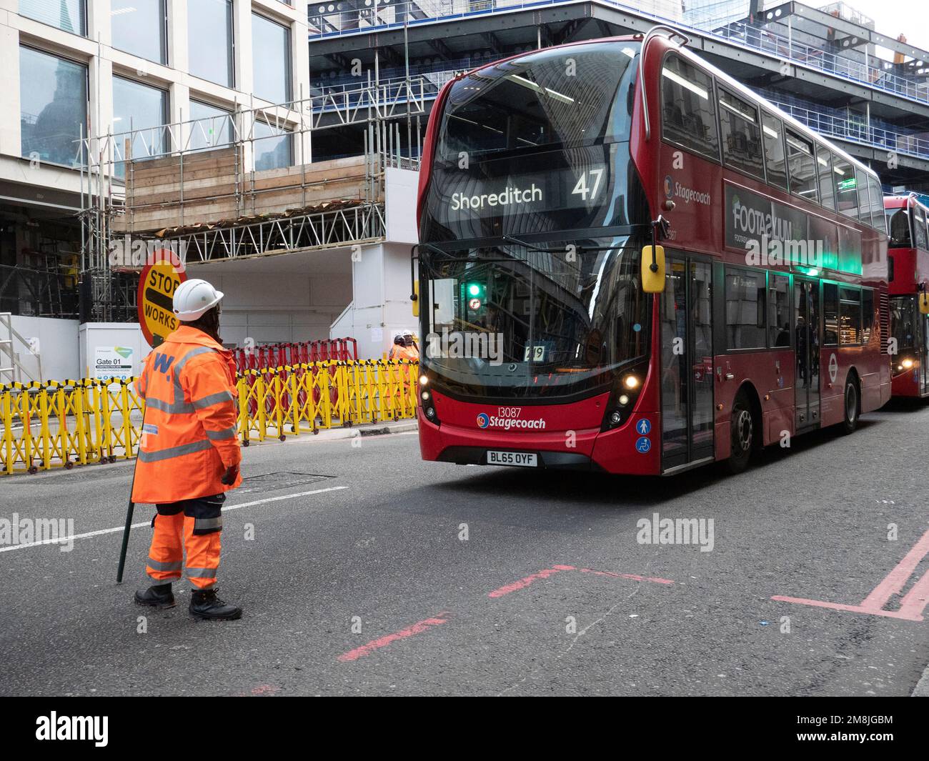 Banksman traffic marshall with fluorescent suit and helmet with stop ...