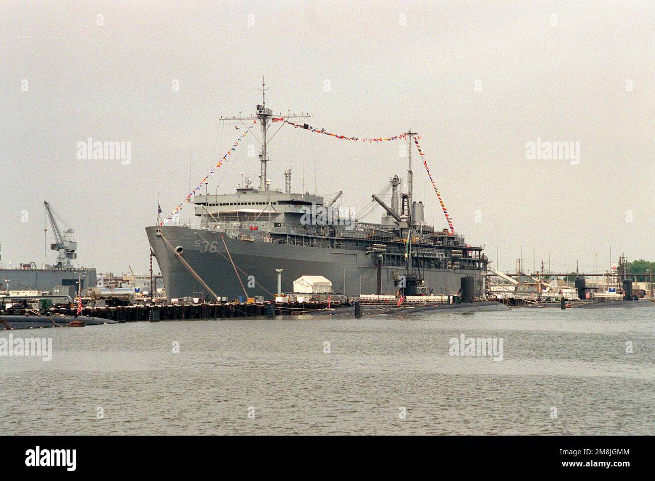 A port bow view of the submarine tender USS L. Y. SPEAR (AS-36) tied up ...