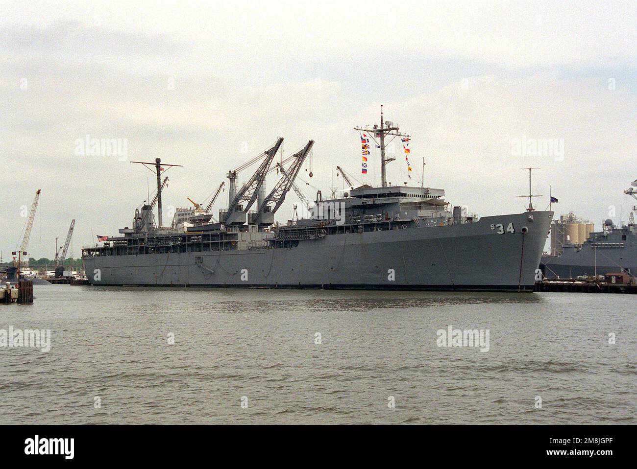 A starboard bow view of the submarine tender USS CANOPUS (AS-34) tied ...