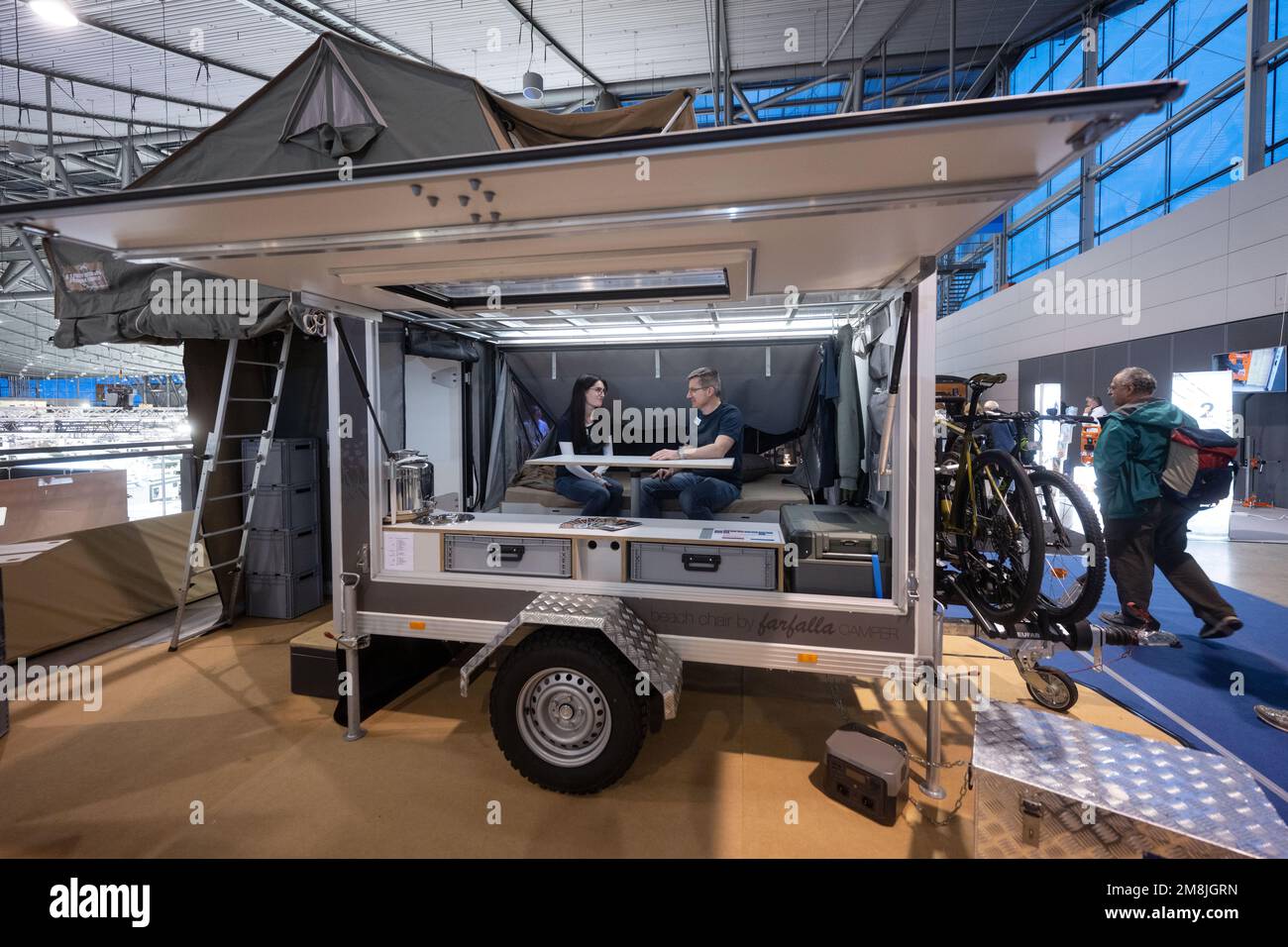 Stuttgart, Germany. 14th Jan, 2023. Stand employees sit in a camping ...
