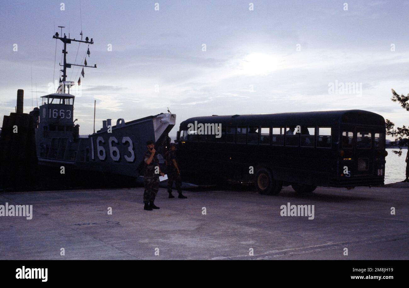 A US Air Force bus carrying Cuban migrants drives onto US Navy Landing ...