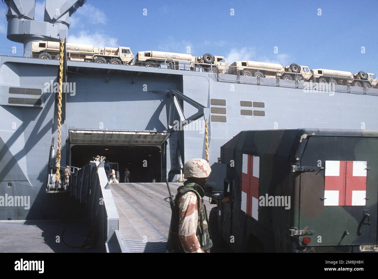 A U.S. Army ambulance drives up the ramp to the USNS Denebola. Subject ...