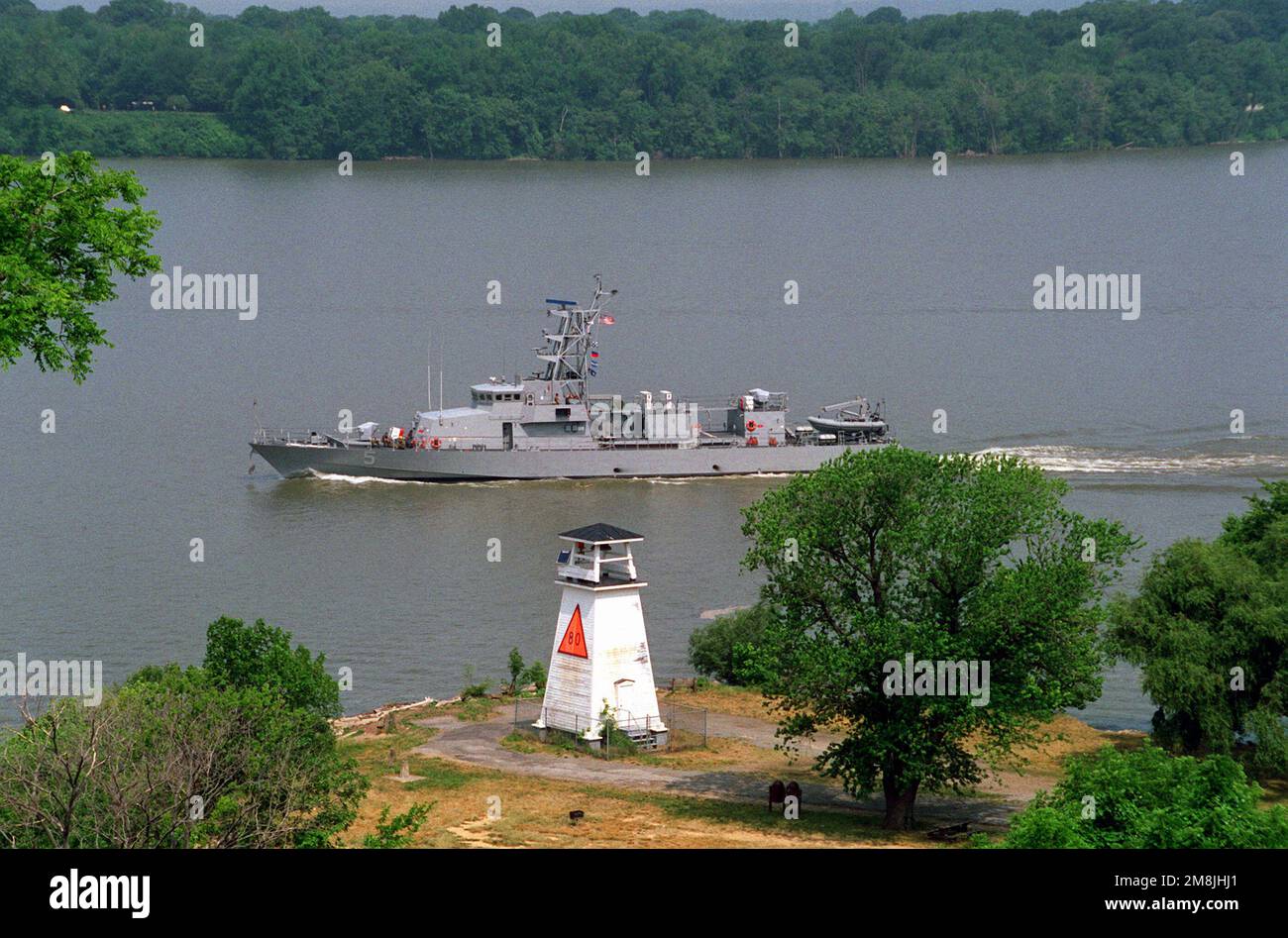 A port side view of the coastal patrol boat USS TYPHOON (PC-5) passing ...