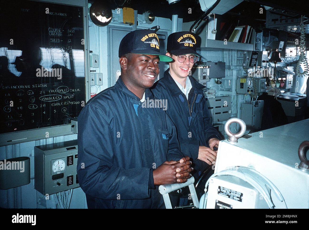 Two Boatswain's Mates of the Watch stand duty on the bridge of the ...